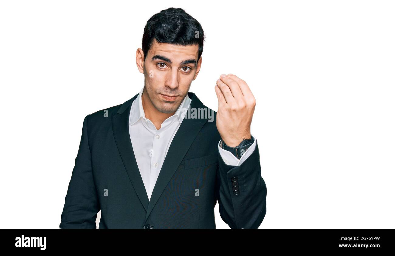 Handsome hispanic man wearing business clothes doing italian gesture ...