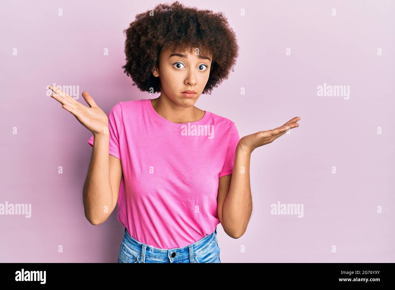 Young hispanic girl wearing casual clothes clueless and confused with ...