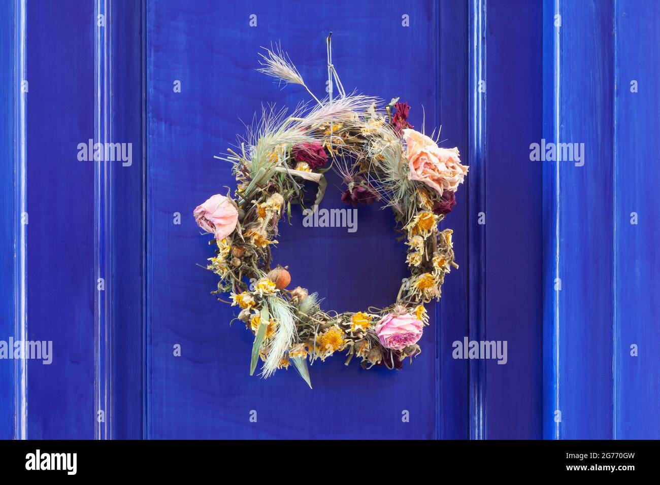 Flower wreath on blue door in old town Chania on the island of Crete ...