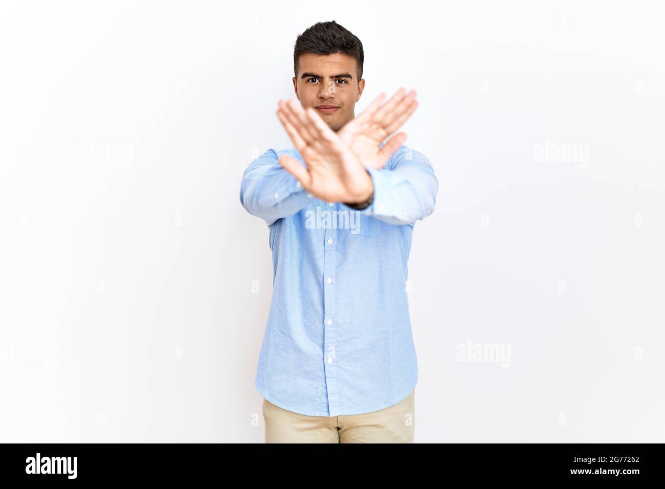 Young hispanic man wearing business shirt standing over isolated ...