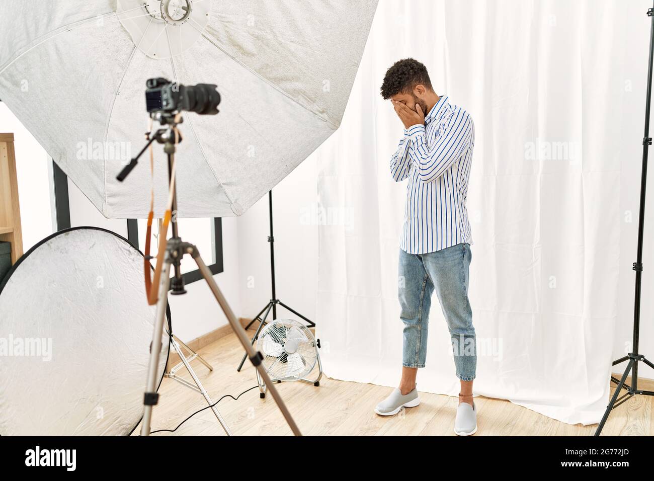 Arab young man posing as model at photography studio with sad ...