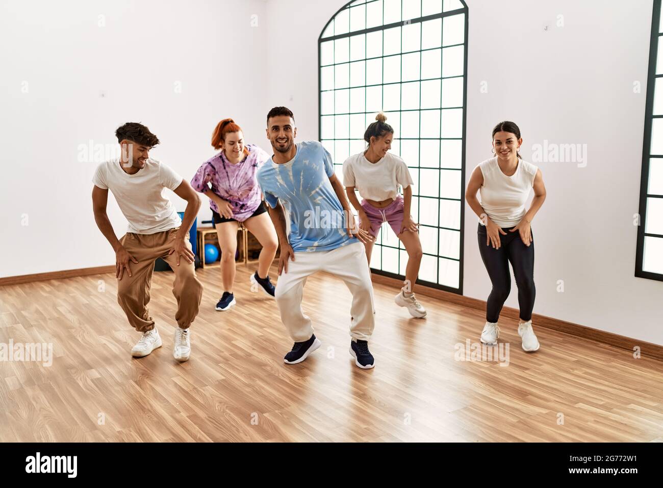 Group of young dancer smiling happy dancing choreography at dance ...