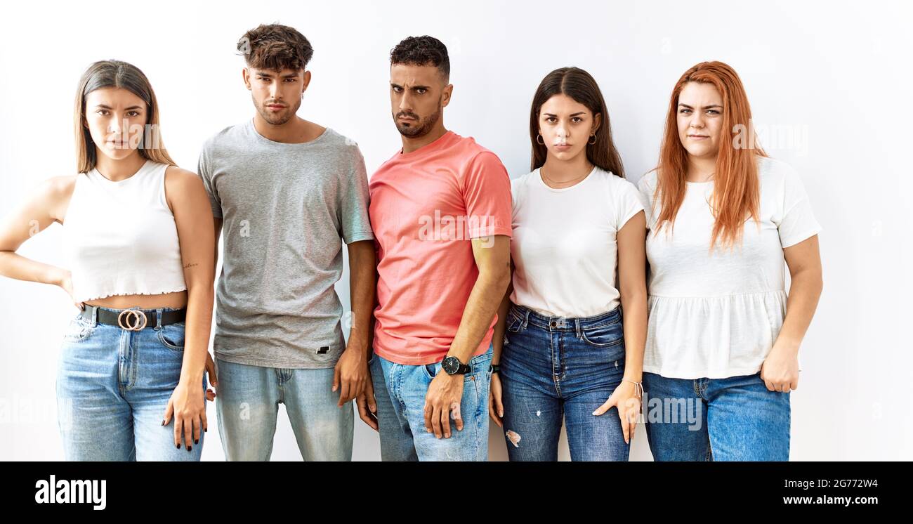 Group of young friends standing together over isolated background ...
