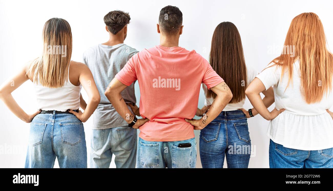 Group of young friends standing together over isolated background ...