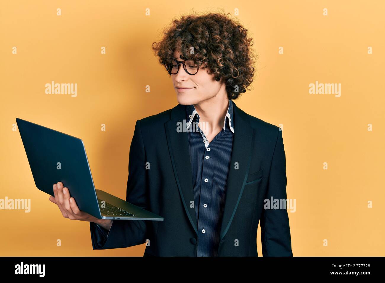 Handsome young man working using computer laptop looking positive and ...