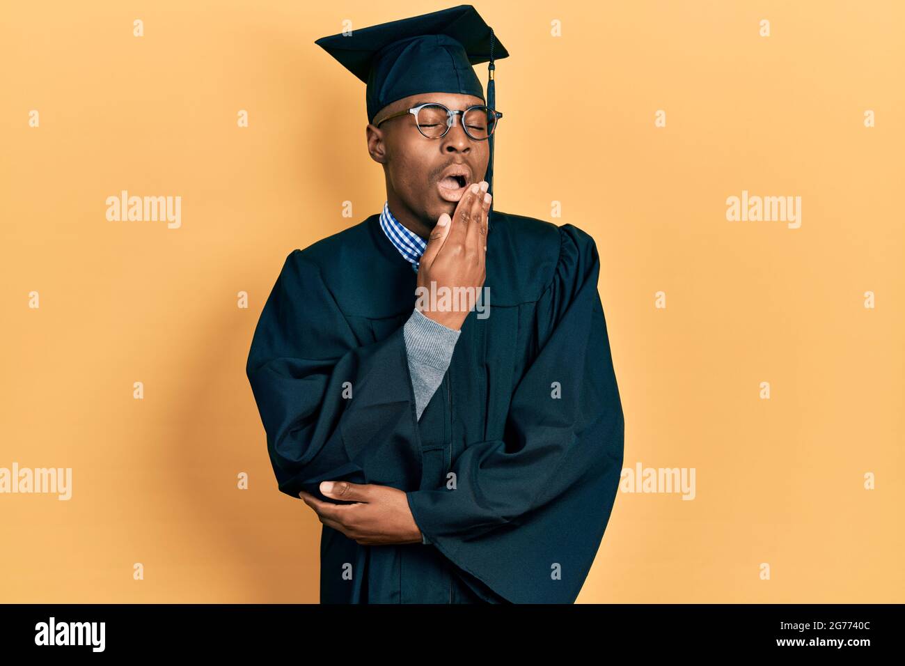 Young african american man wearing graduation cap and ceremony robe ...