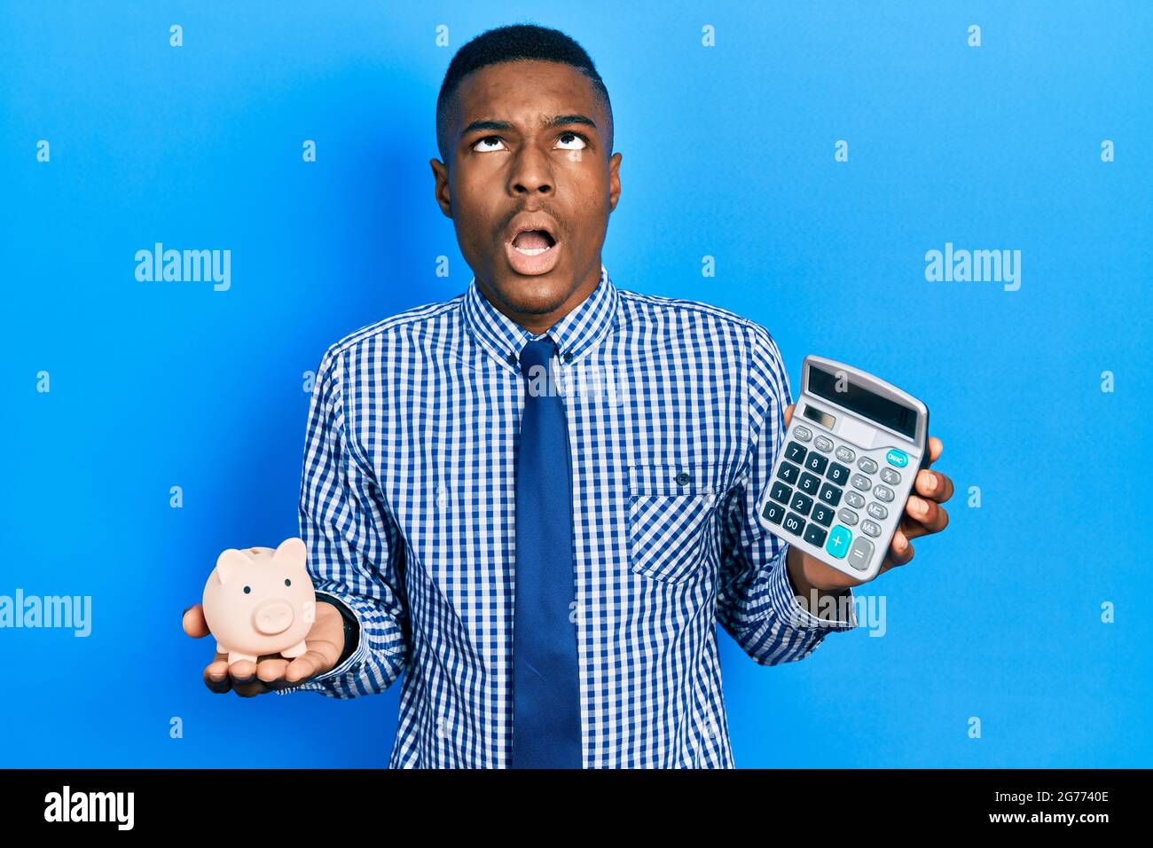 Young african american man calculating money savings angry and mad ...