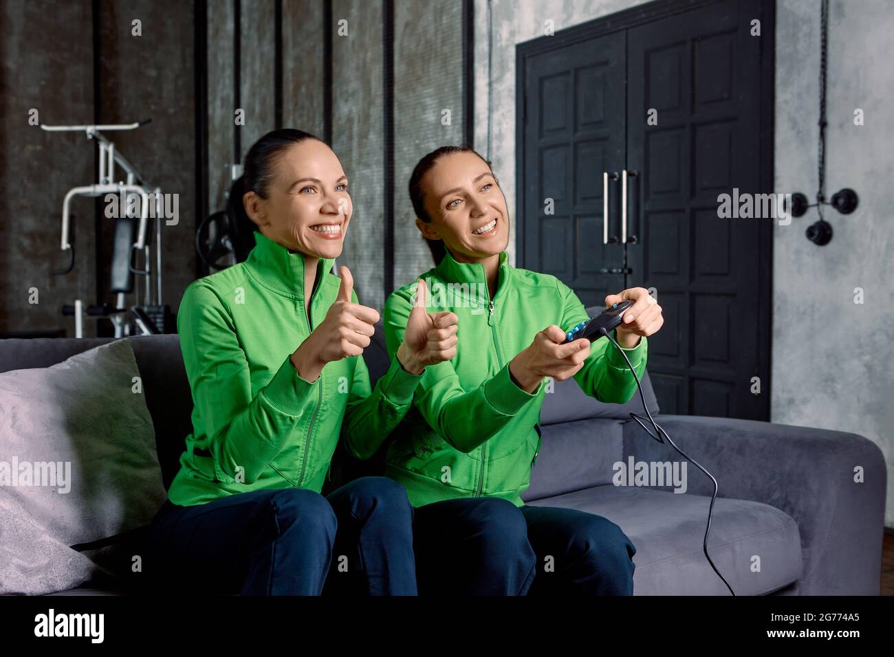 Women play video games with console and joystick Stock Photo - Alamy