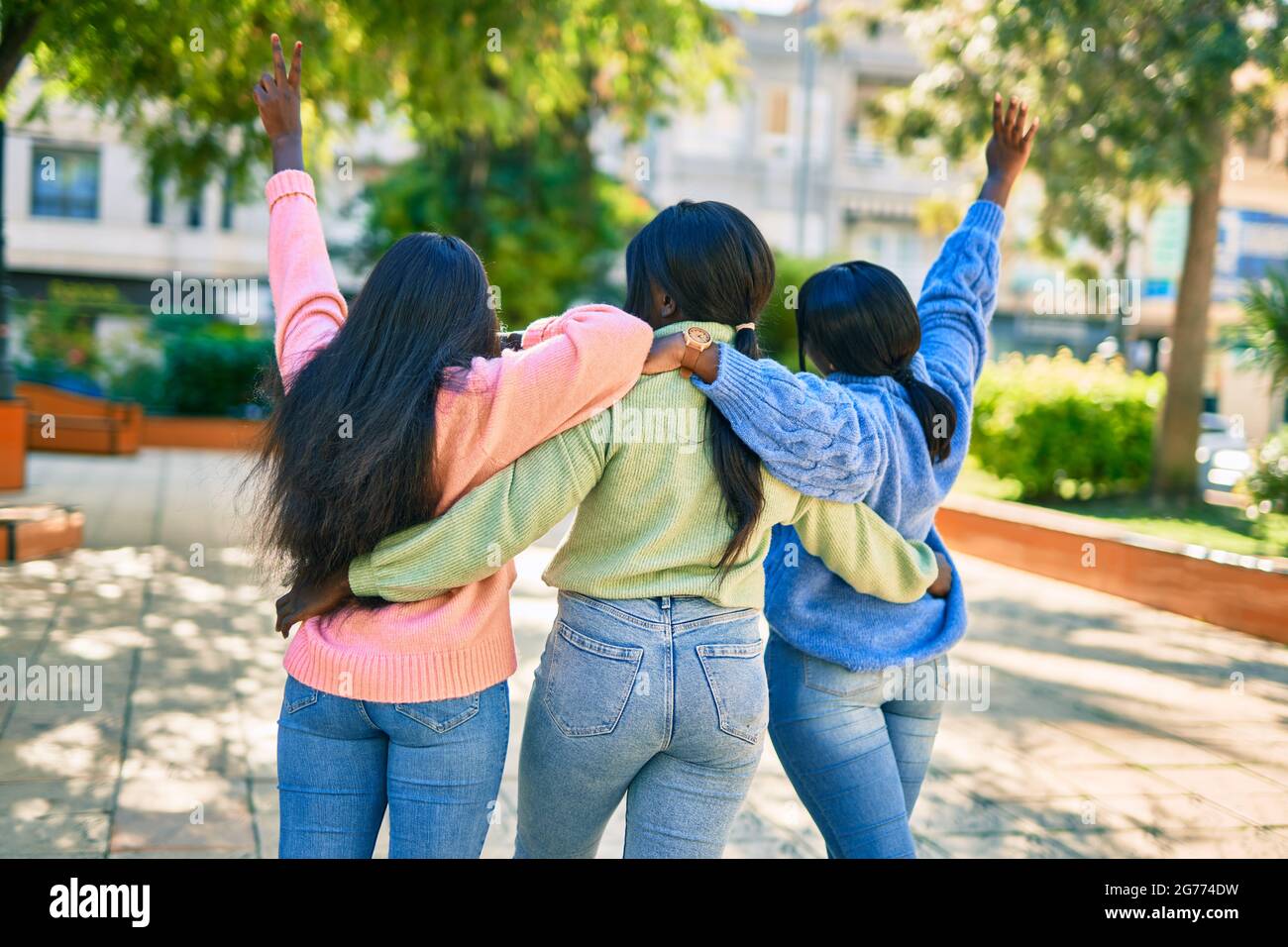 Three african american friends on back view walking at the park Stock ...