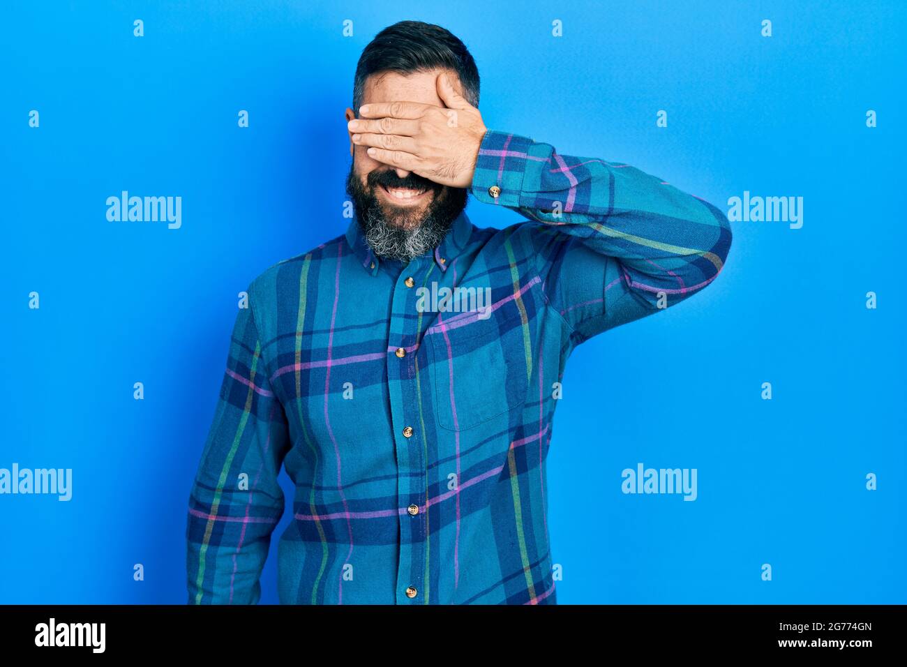 Young hispanic man wearing casual clothes smiling and laughing with ...