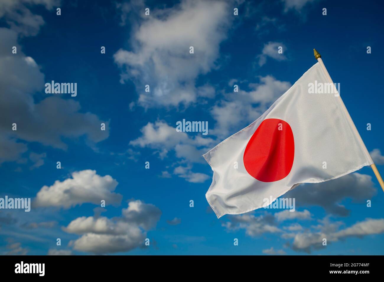 Japan flag waving in bright sunny blue sky with puffy clouds Stock ...