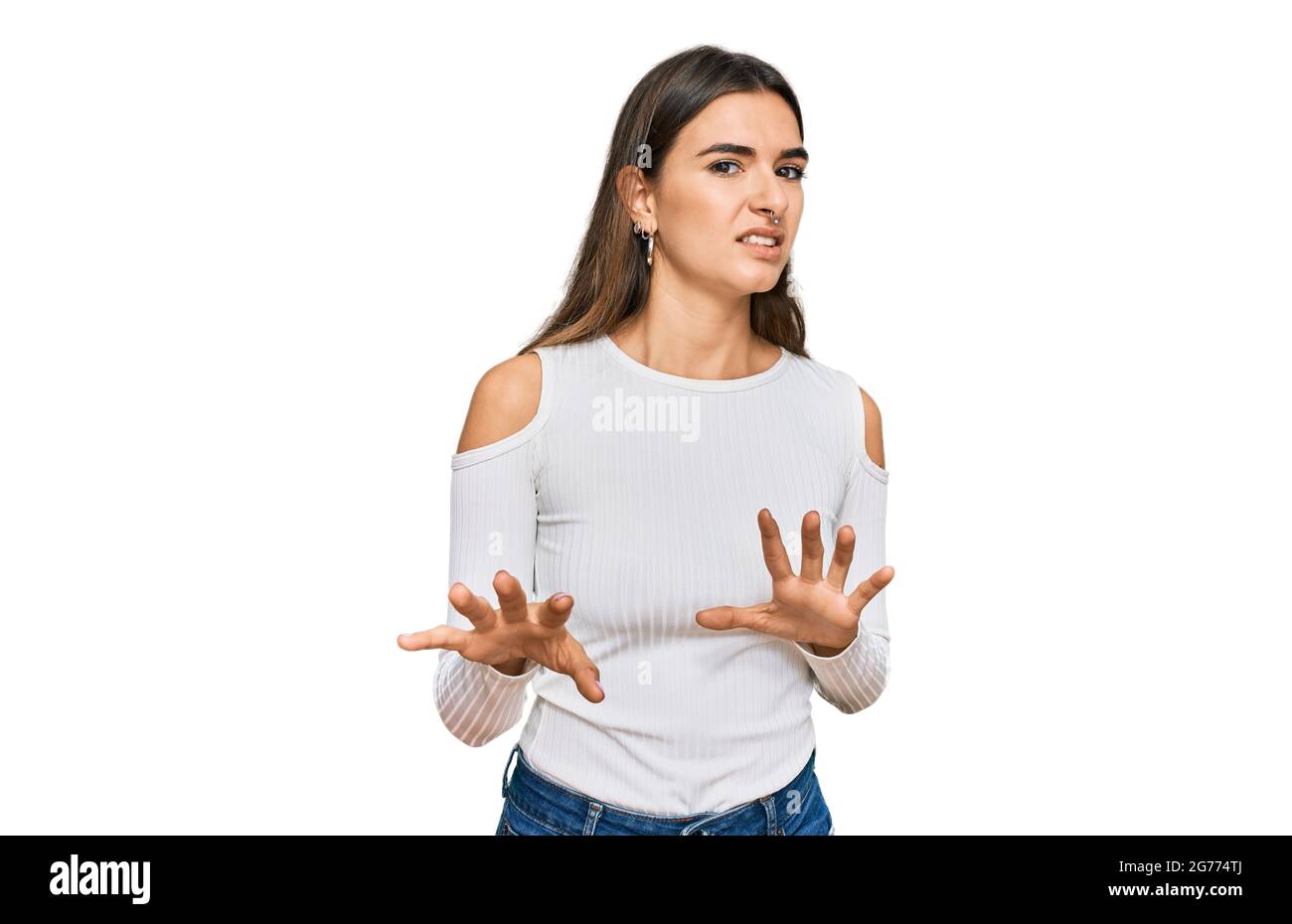 Young hispanic woman wearing casual clothes disgusted expression ...