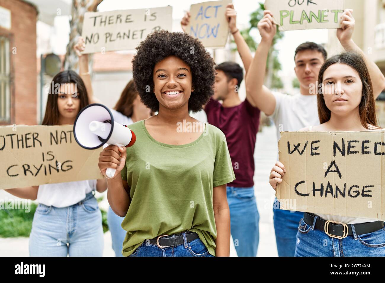 Group of young friends protesting and giving slogans at the street ...