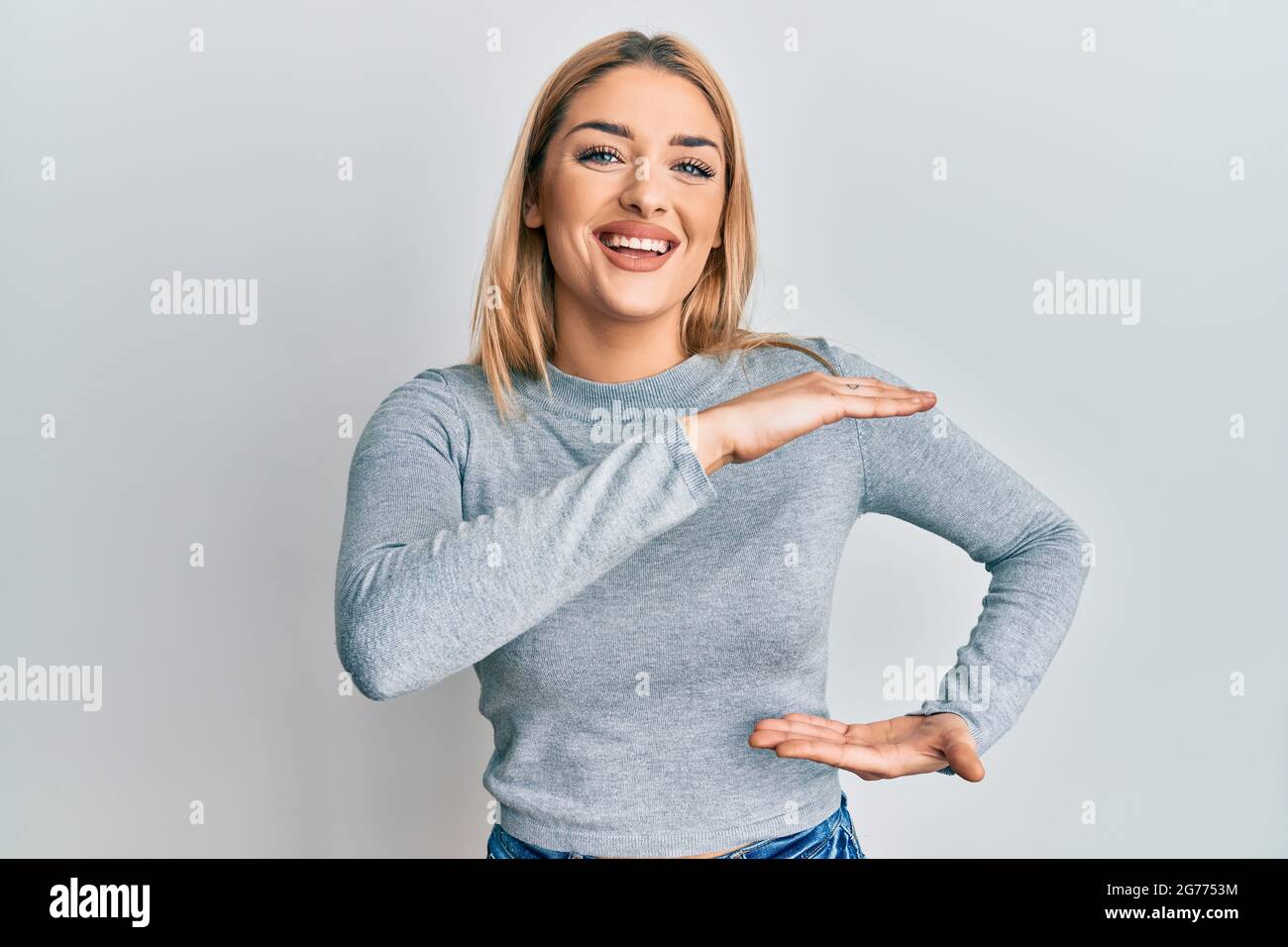 Young caucasian woman wearing casual clothes gesturing with hands ...