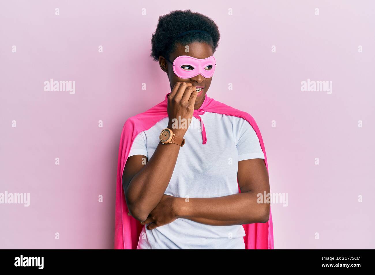Young african american girl wearing superhero mask and cape costume ...