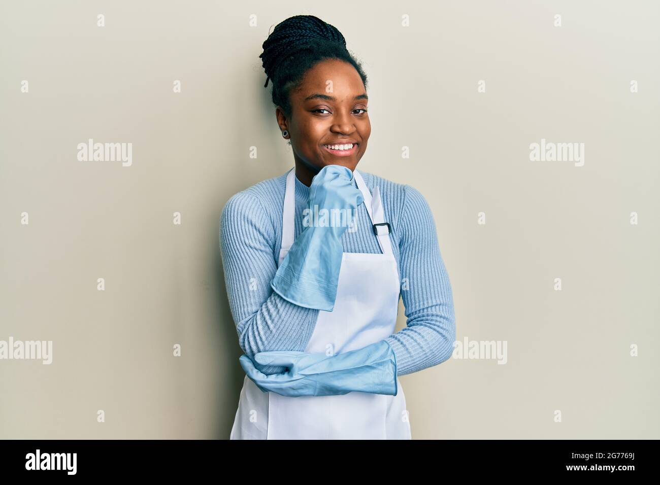 African american woman with braided hair wearing cleaner apron and ...
