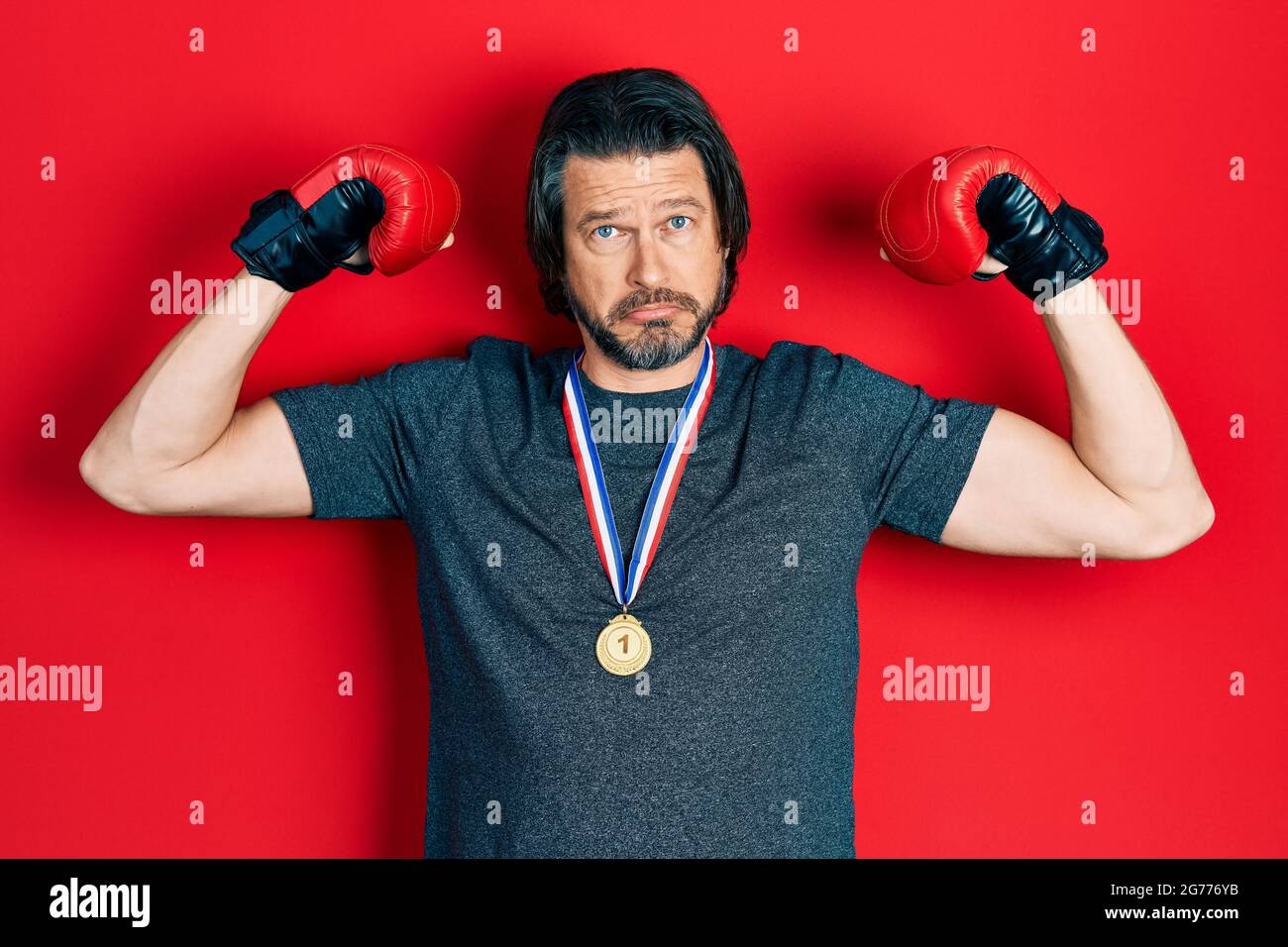 Middle age caucasian man wearing first place medal on boxing ...