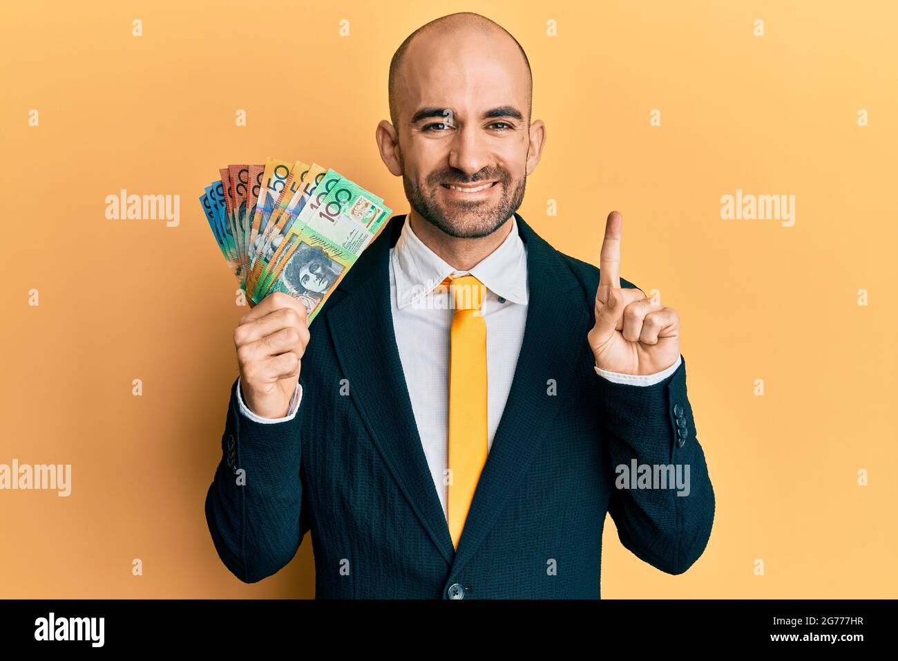 Young hispanic business man holding canadian dollars smiling with an ...