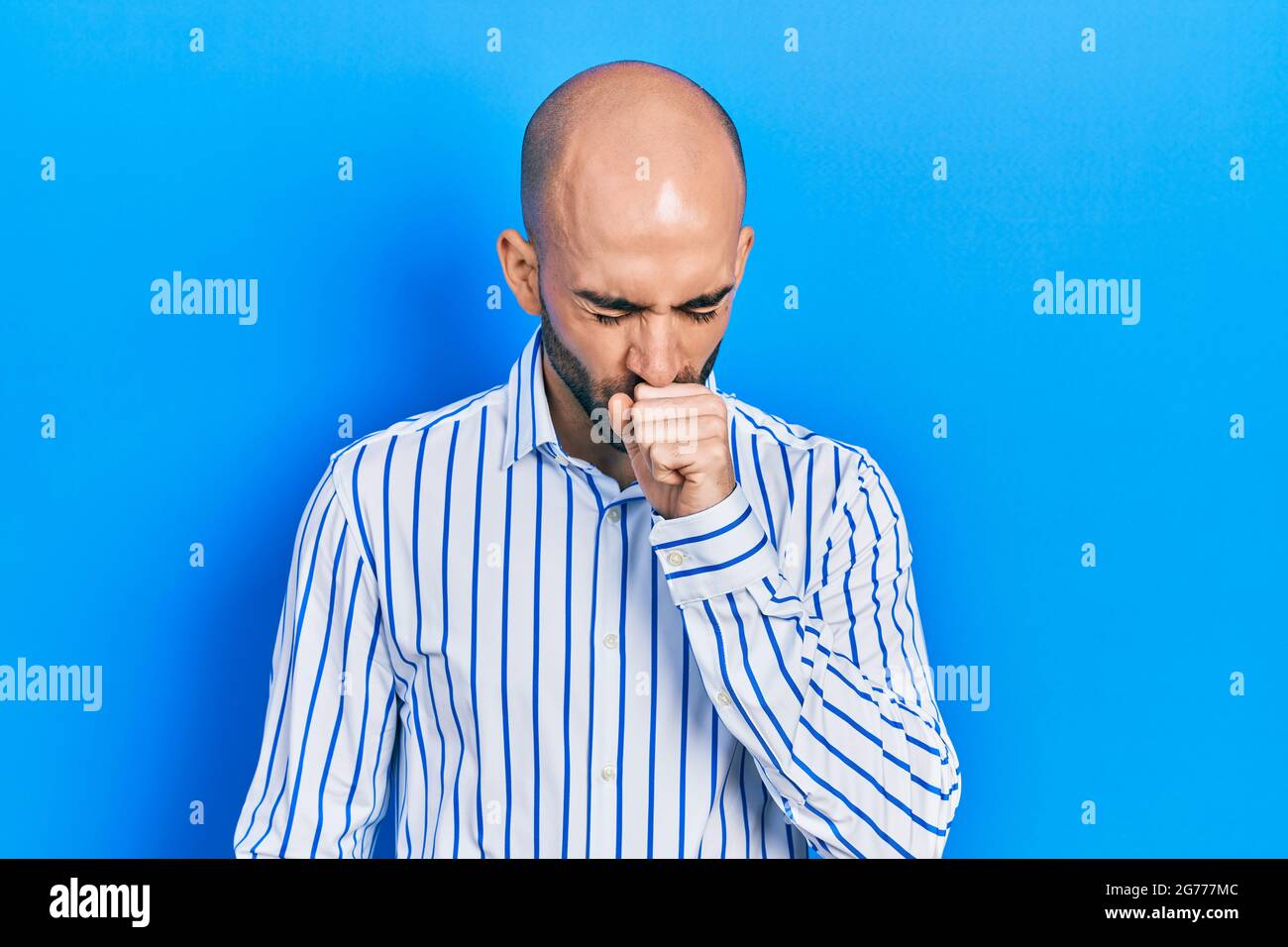 Young bald man wearing elegant clothes feeling unwell and coughing as ...