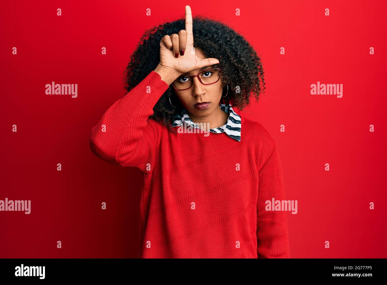 Beautiful african american woman with afro hair wearing sweater and ...