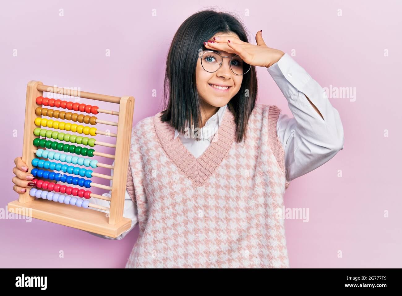 Young brunette woman holding traditional abacus stressed and frustrated ...