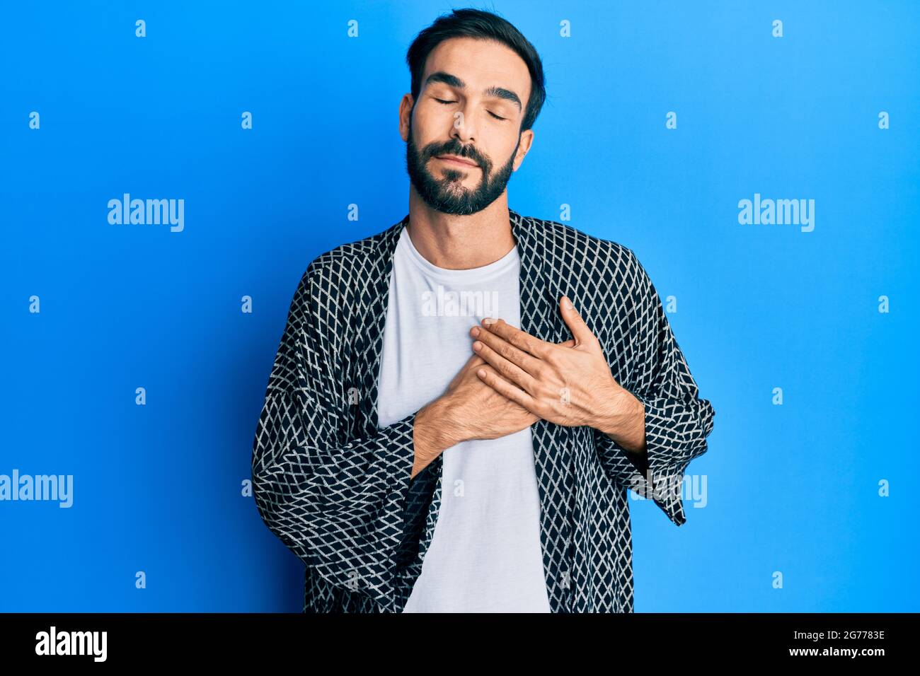 Young hispanic man wearing casual clothes smiling with hands on chest ...