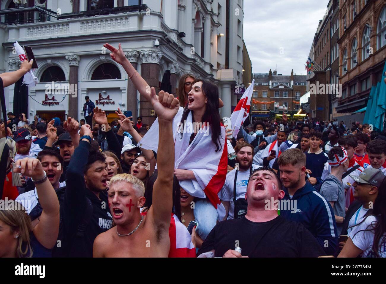 London, UK. 11th July, 2021. Excited England supporters sing and chant ...