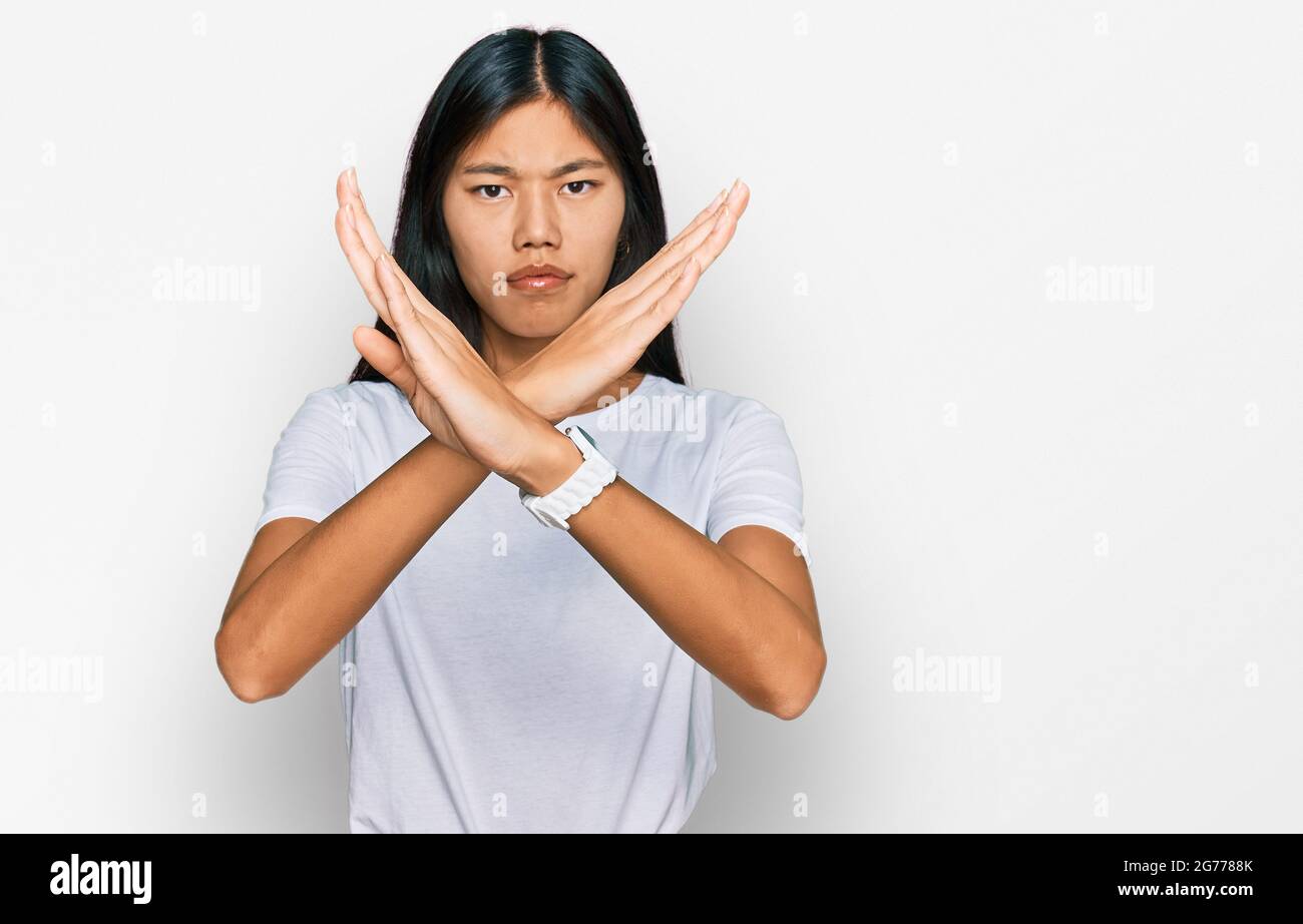 Beautiful young asian woman wearing casual white t shirt rejection ...