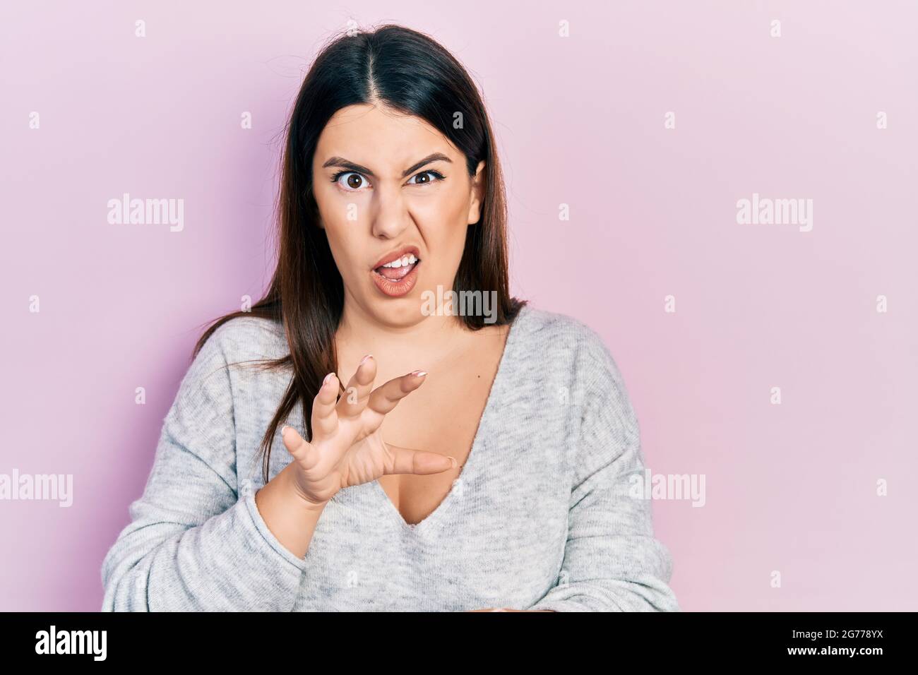 Young hispanic woman wearing casual clothes disgusted expression ...