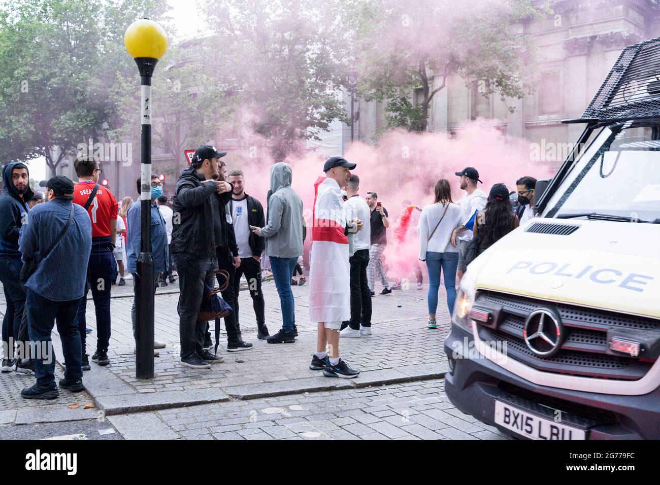 English football fans singing and letting off smoke flares congregate ...