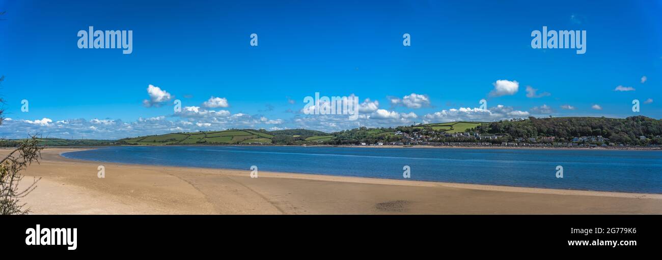 A panoramic shot of LLansteffan beach with clear blue water in southern ...