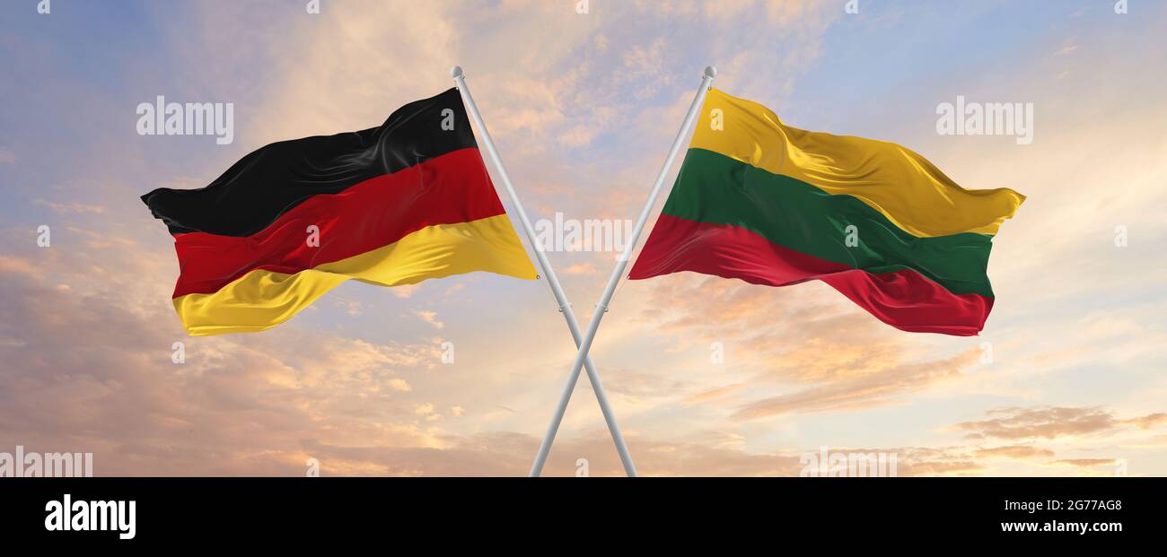 flags of Germany and LITHUANIA waving in the wind on flagpoles against ...