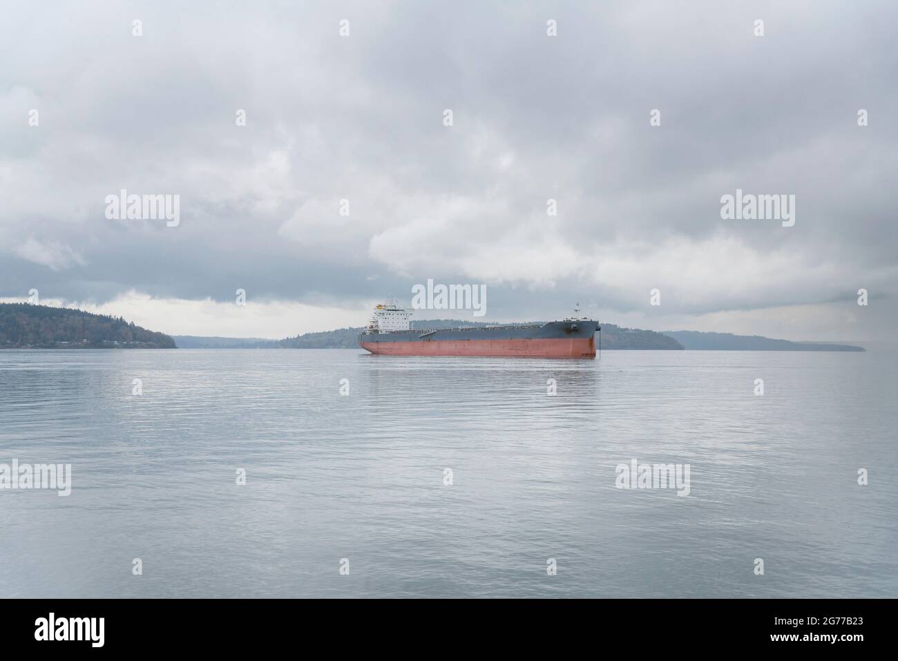 Empty container ship at Tacoma under a dark cloudy sky Stock Photo - Alamy