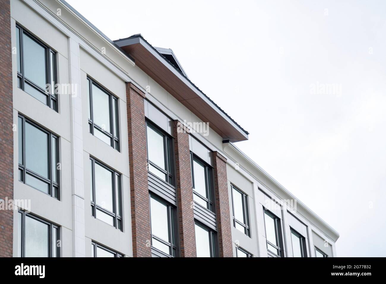 Exterior of an upper part of a flat building with a view of the sky ...