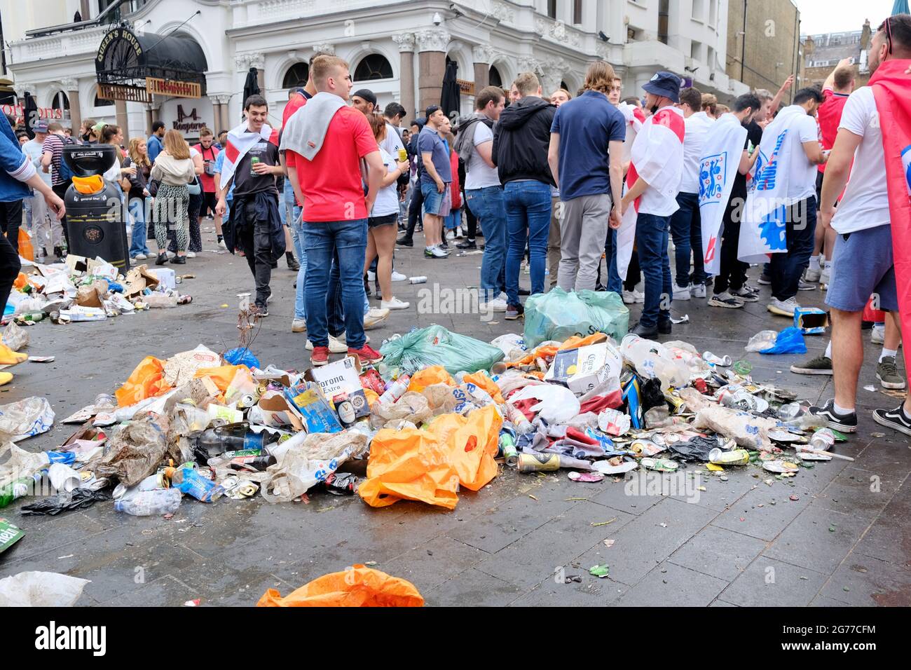 England football fans wander through rubbish left in Leicester Square ...