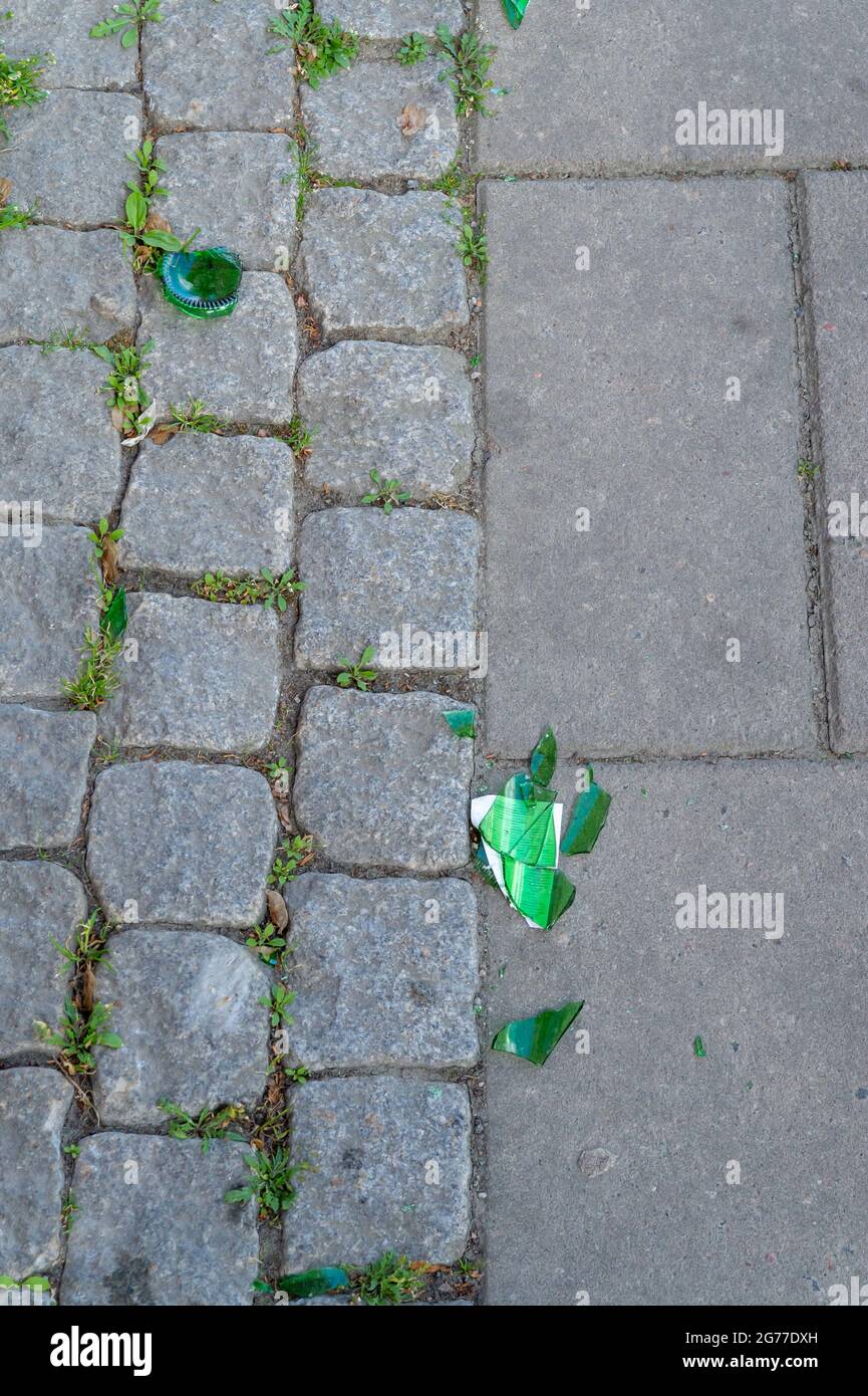 A broken glass bottle, green sharp shards of glass Stock Photo - Alamy