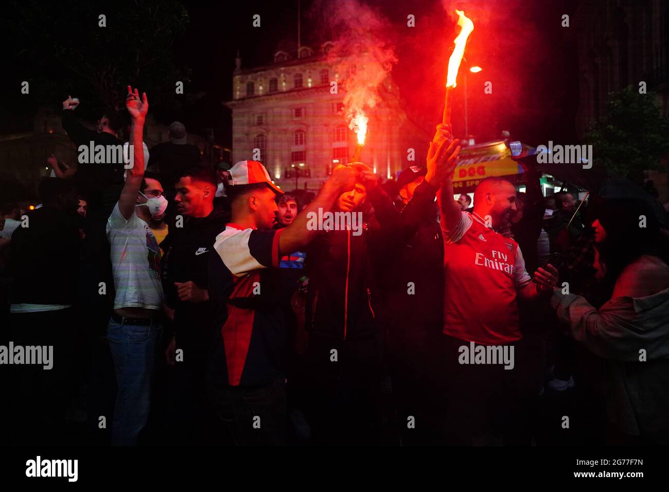Football fans wave flares in Piccadilly Circus, London, after Italy ...