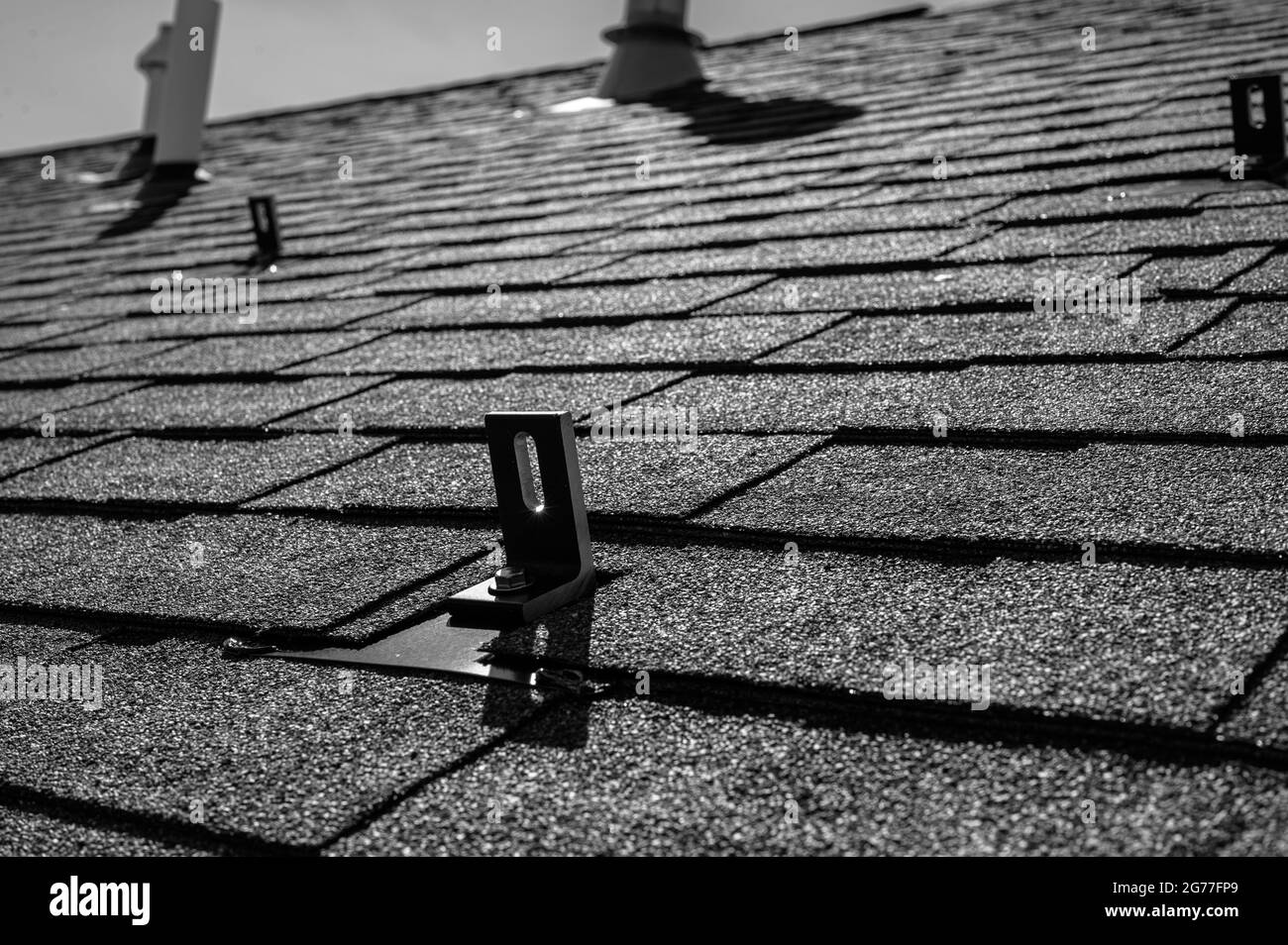 Residential asphalt shingle roof with metal anchors installed for the ...