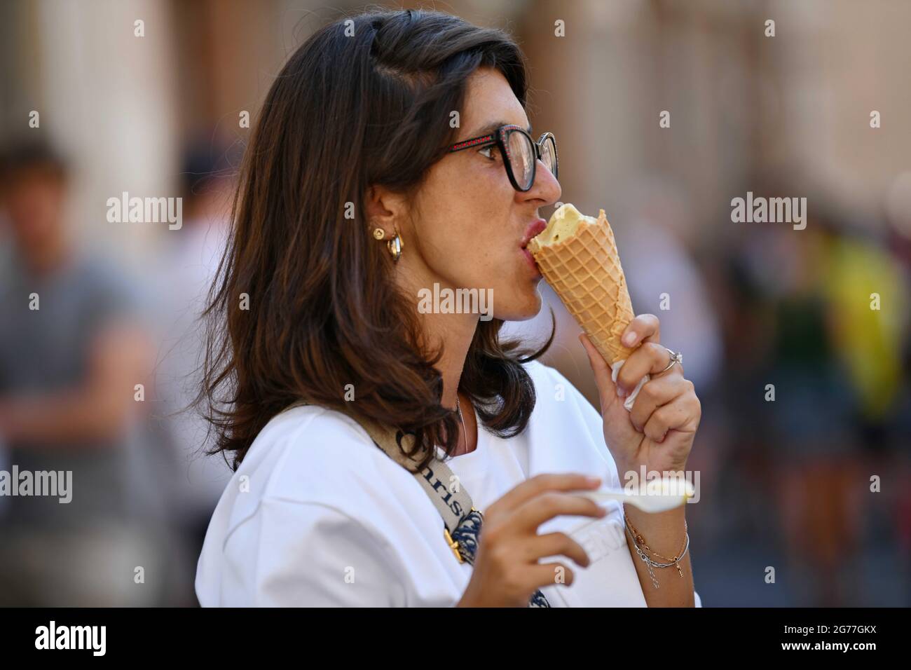 Rome, Italy. 11th July, 2021. A woman eats gelato ice cream in Rome ...