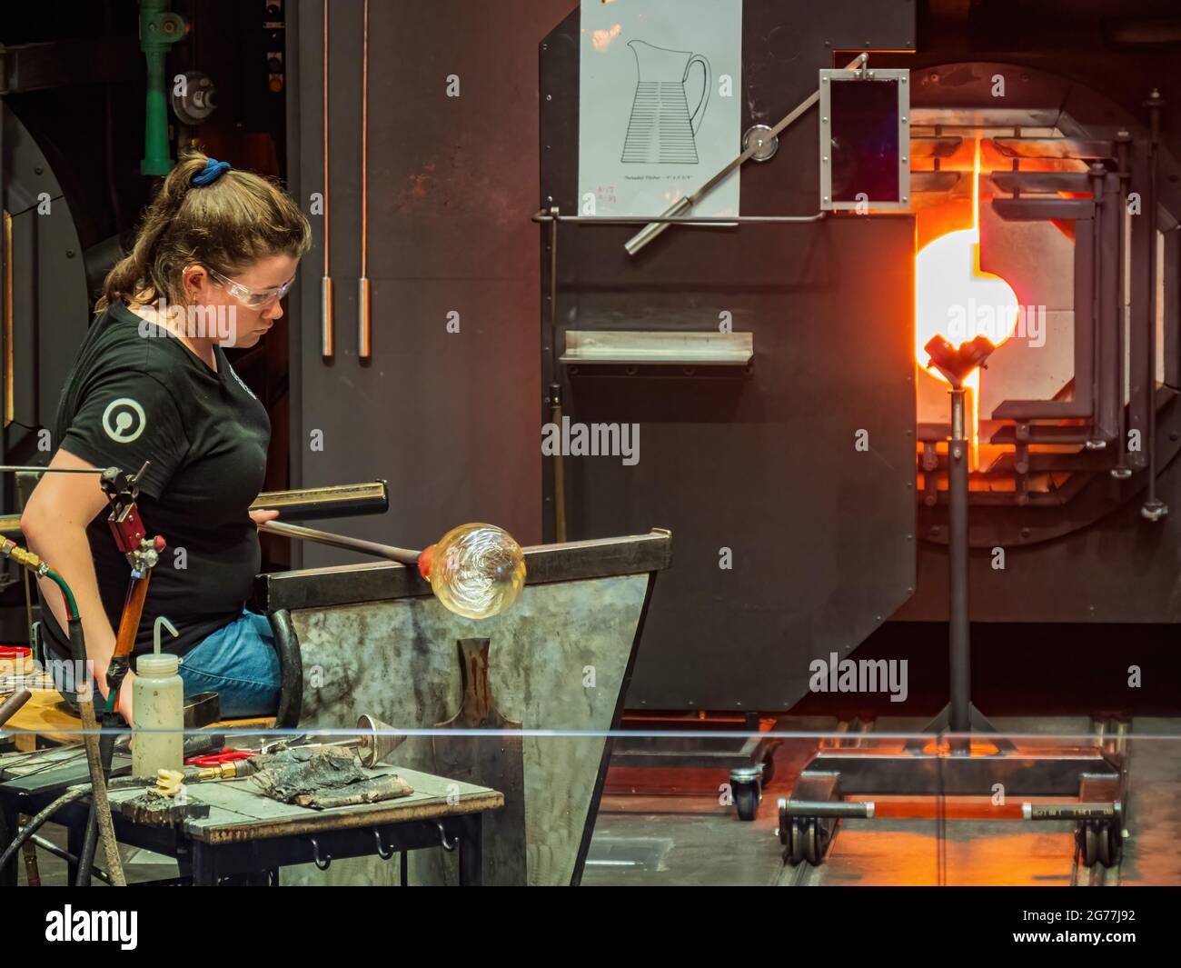 New York, JUL 6, 2021 - Woman working on making glass in the Corning ...