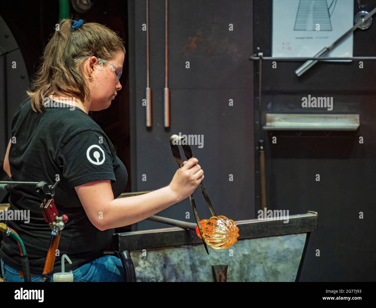 New York, JUL 6, 2021 - Woman working on making glass in the Corning ...