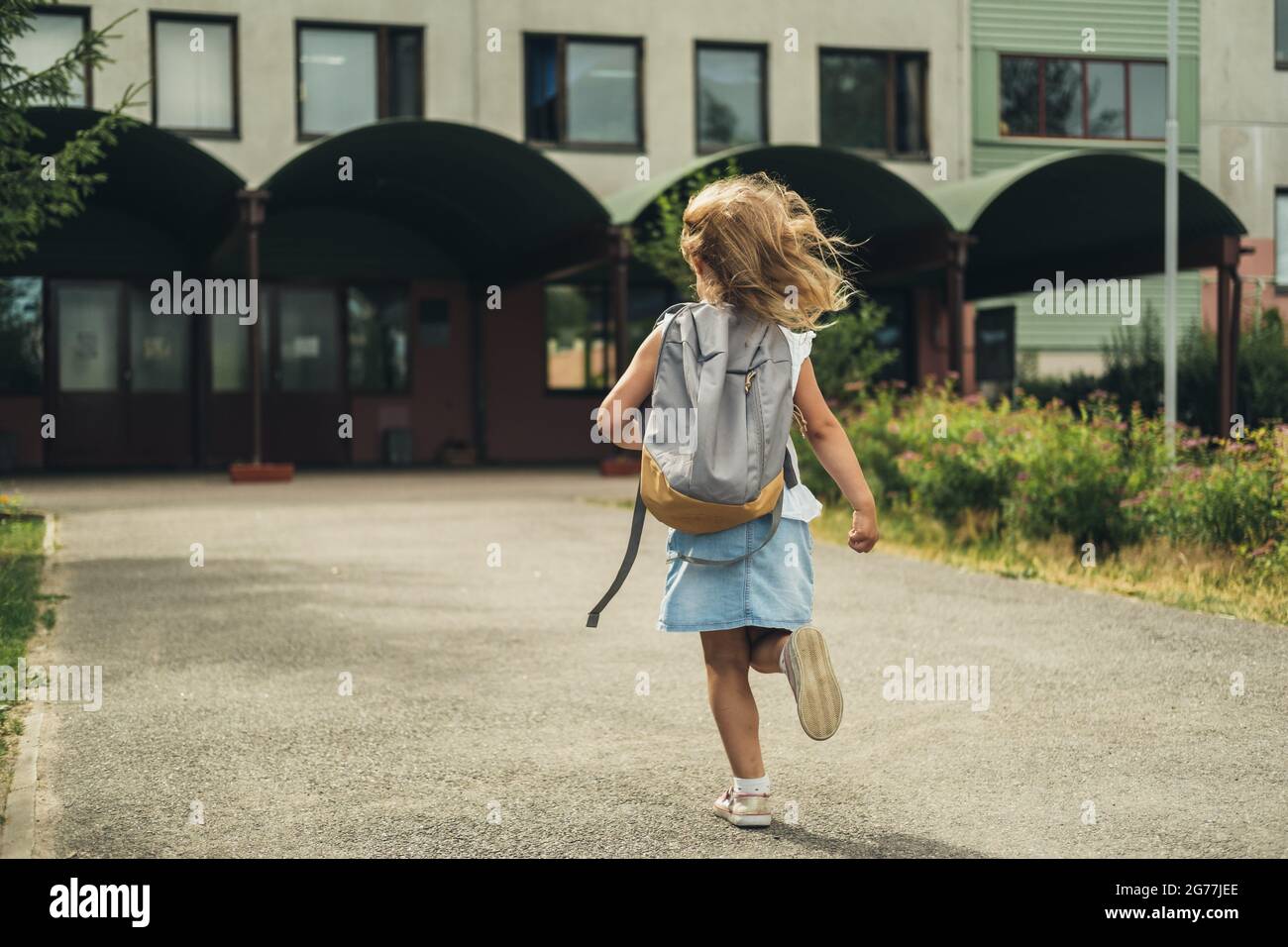 The girl running to school with bags behind backs and books. Students ...