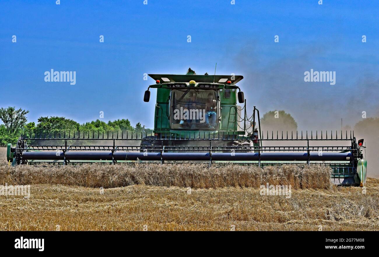 An S770 John Deere combine with a 735FD cutter header attached in the ...