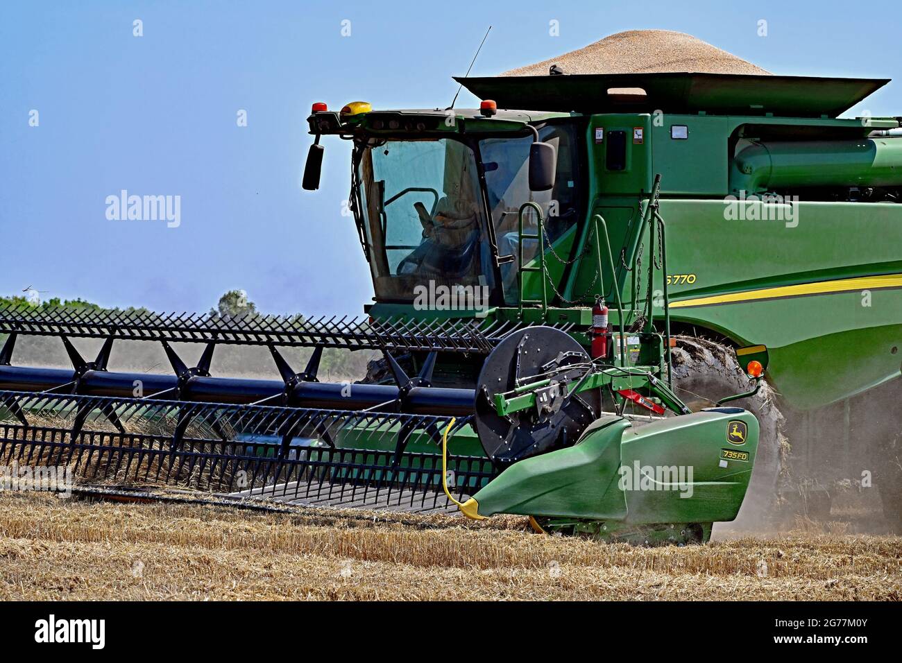 With it’s hopper full of 300 bushels of winter wheat a S770 John Deere ...