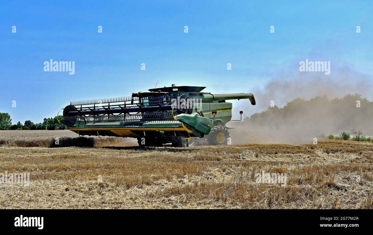 An S770 John Deere combine with a 735FD cutter header attached in the ...
