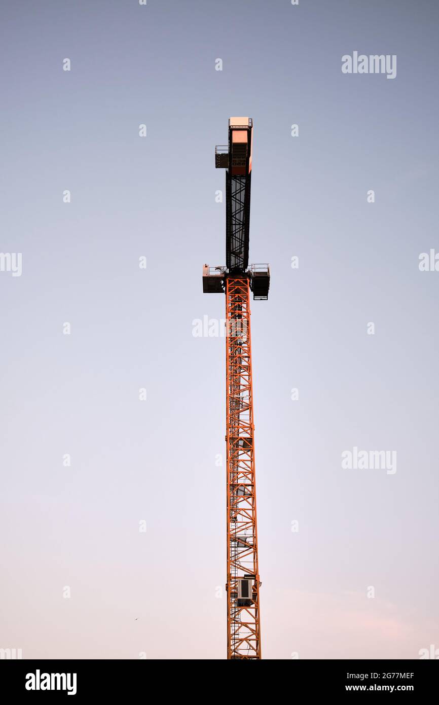 Vertical low angle shot of a construction tower under the blue sky ...