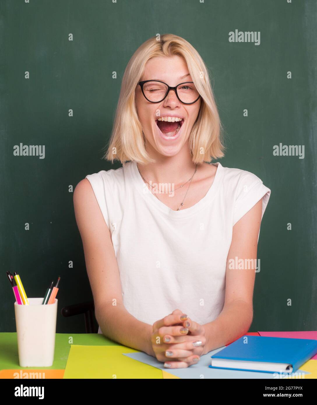 Happy funny teacher winking. Portrait of young caucasian female teacher ...