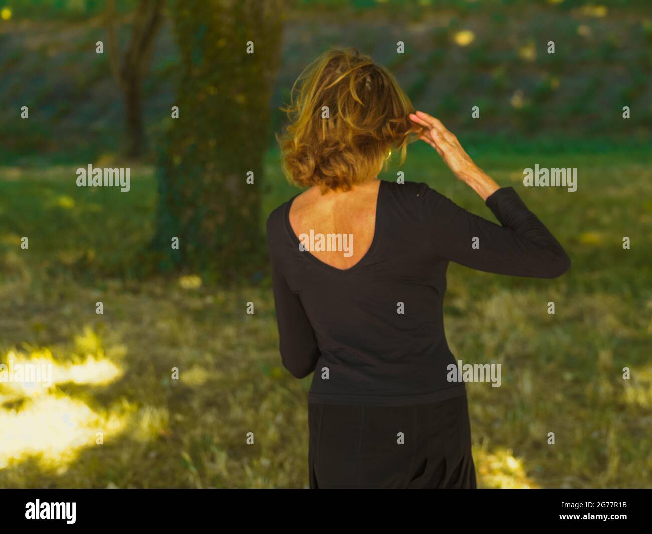Back view of a senior woman wearing a black dress Stock Photo - Alamy