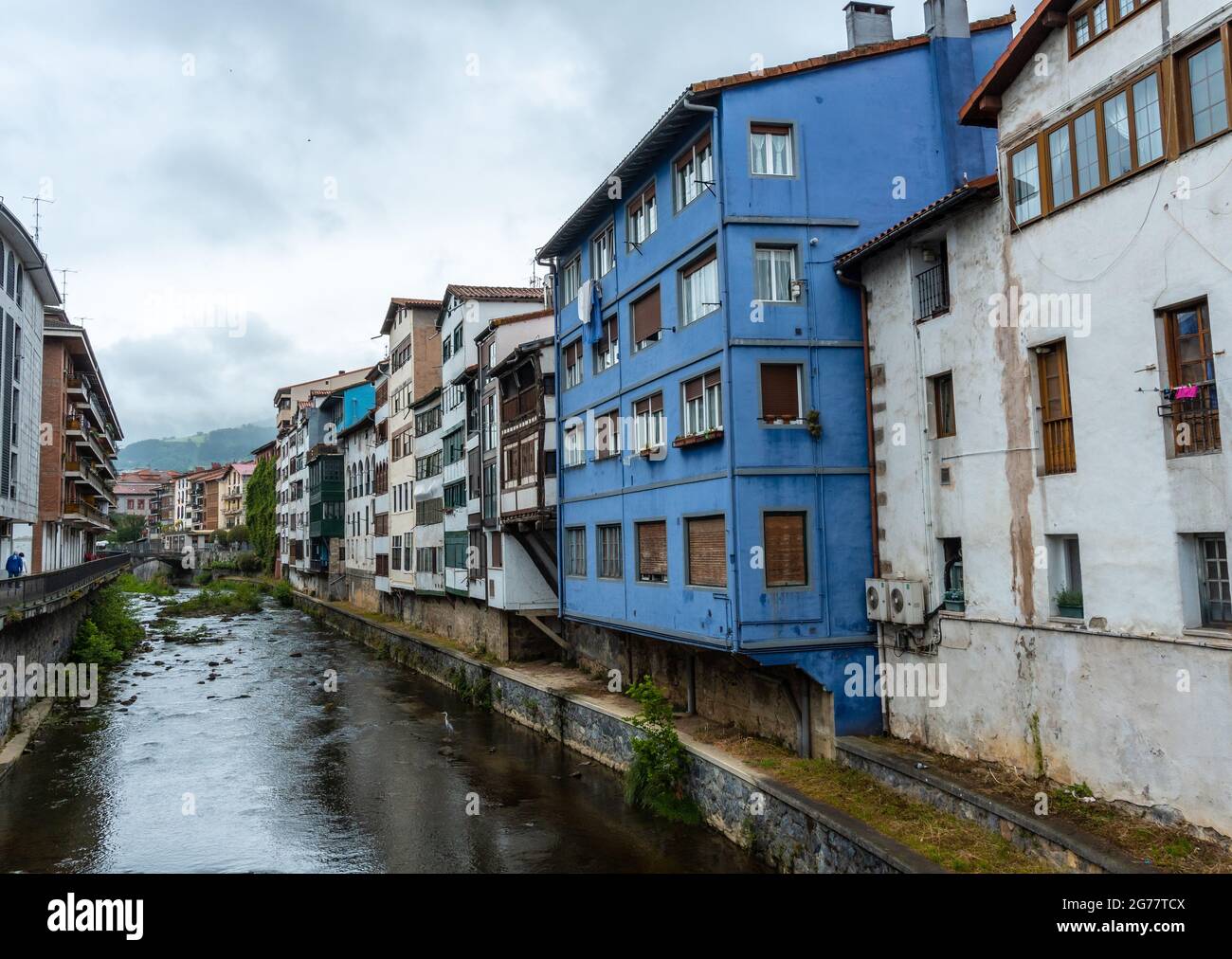 Traditional blue houses in the town of Azkoitia next to the Urola river ...