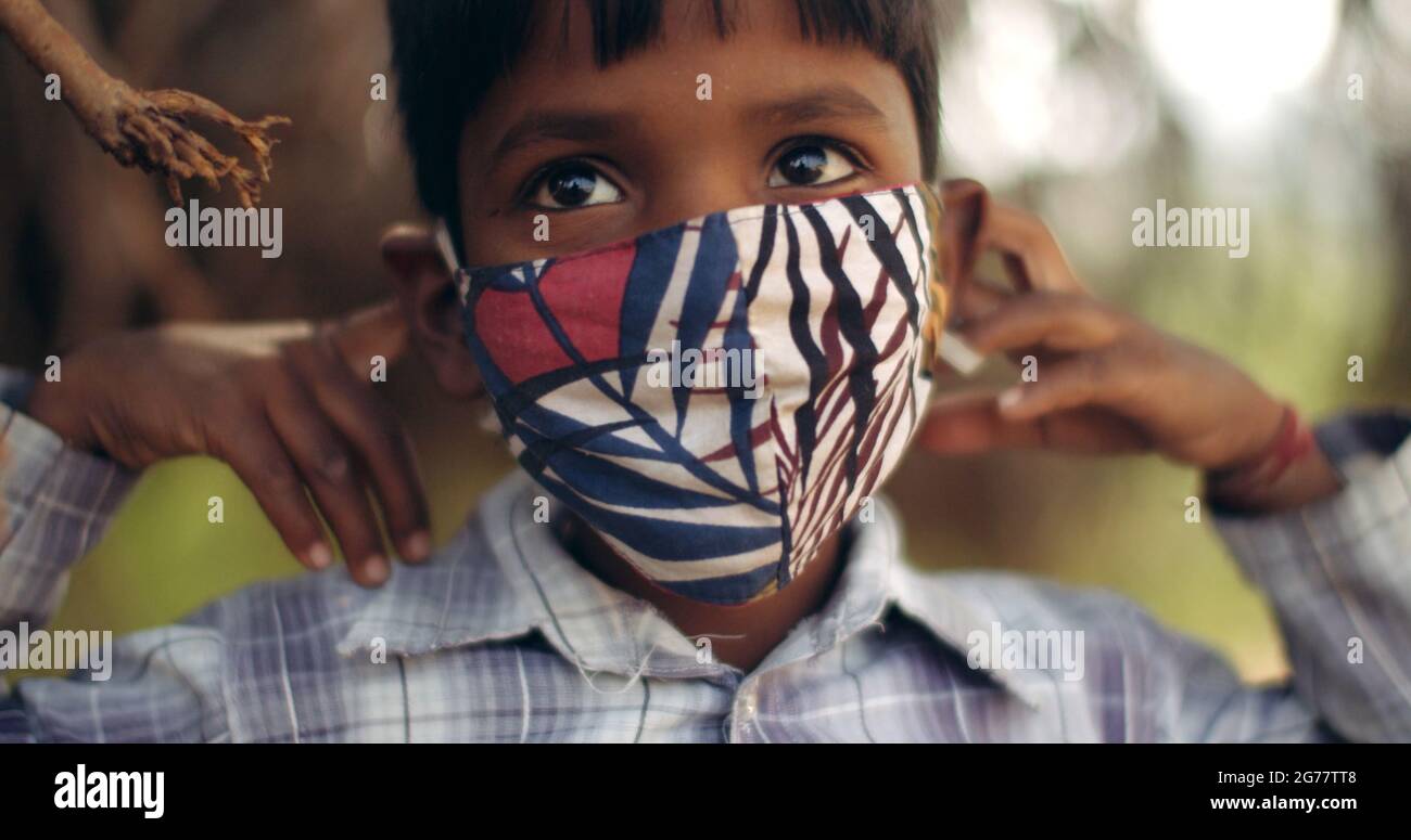 Closeup shot of an Indian boy wearing a mask- new normal concept Stock ...